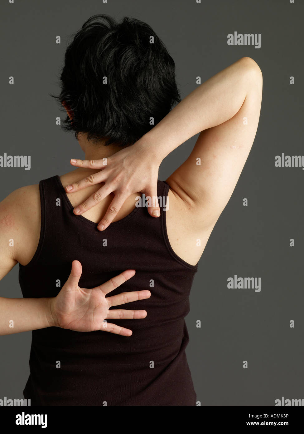Woman with hands behind her back stretching rear view Stock Photo - Alamy