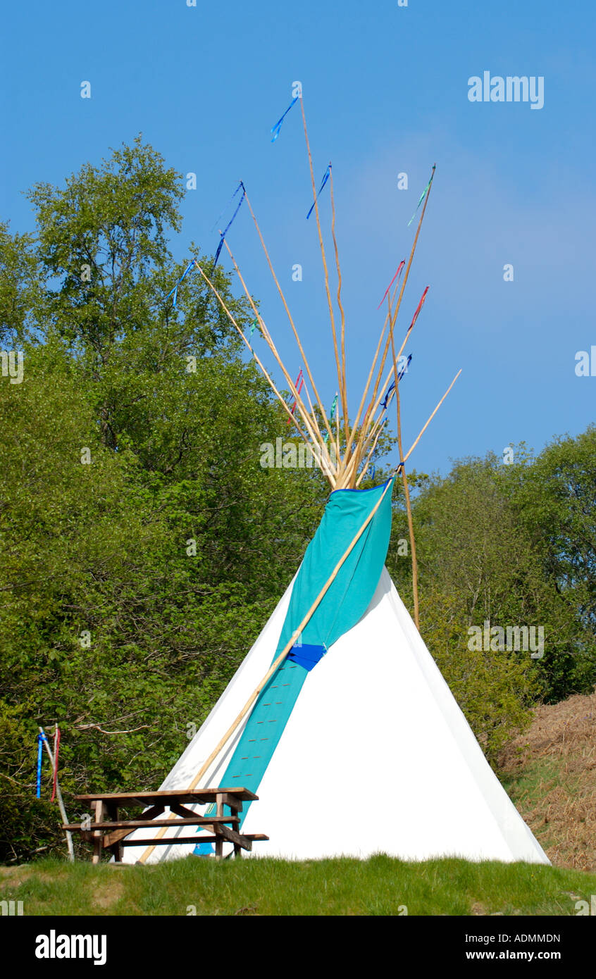 Tipi with poles and ribbons at specialist teepee campsite on farm in ...