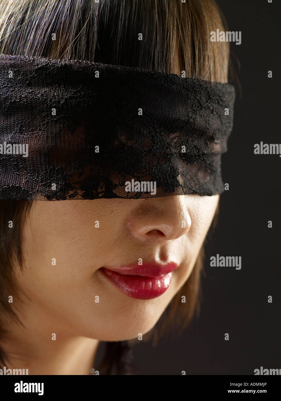 Woman wearing blindfold Stock Photo - Alamy