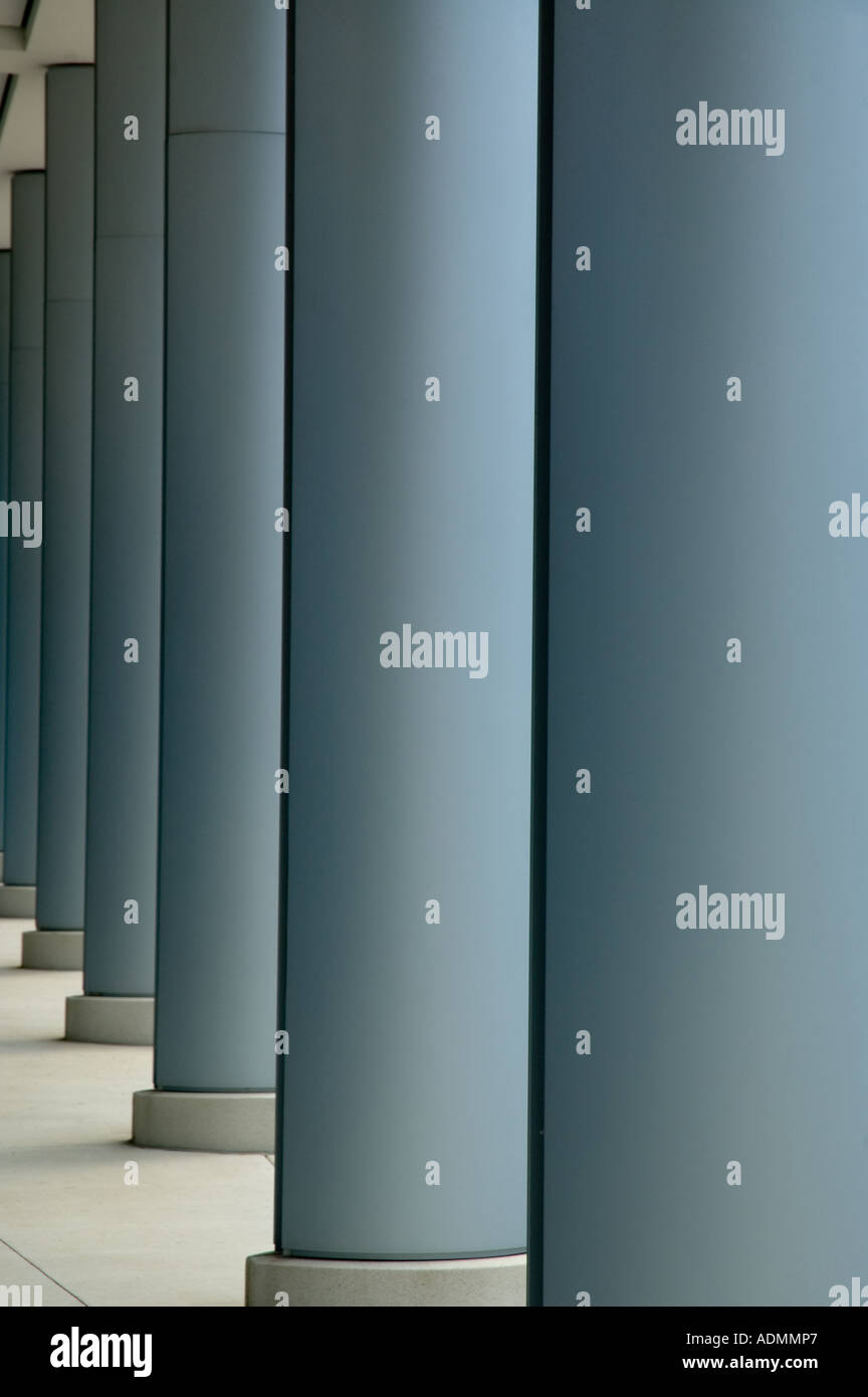 Line of steel blue pillars outside front of modern building Stock Photo ...