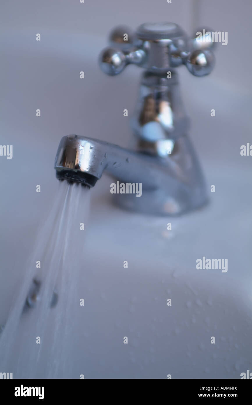 A Tap in a bathroom running water Stock Photo - Alamy