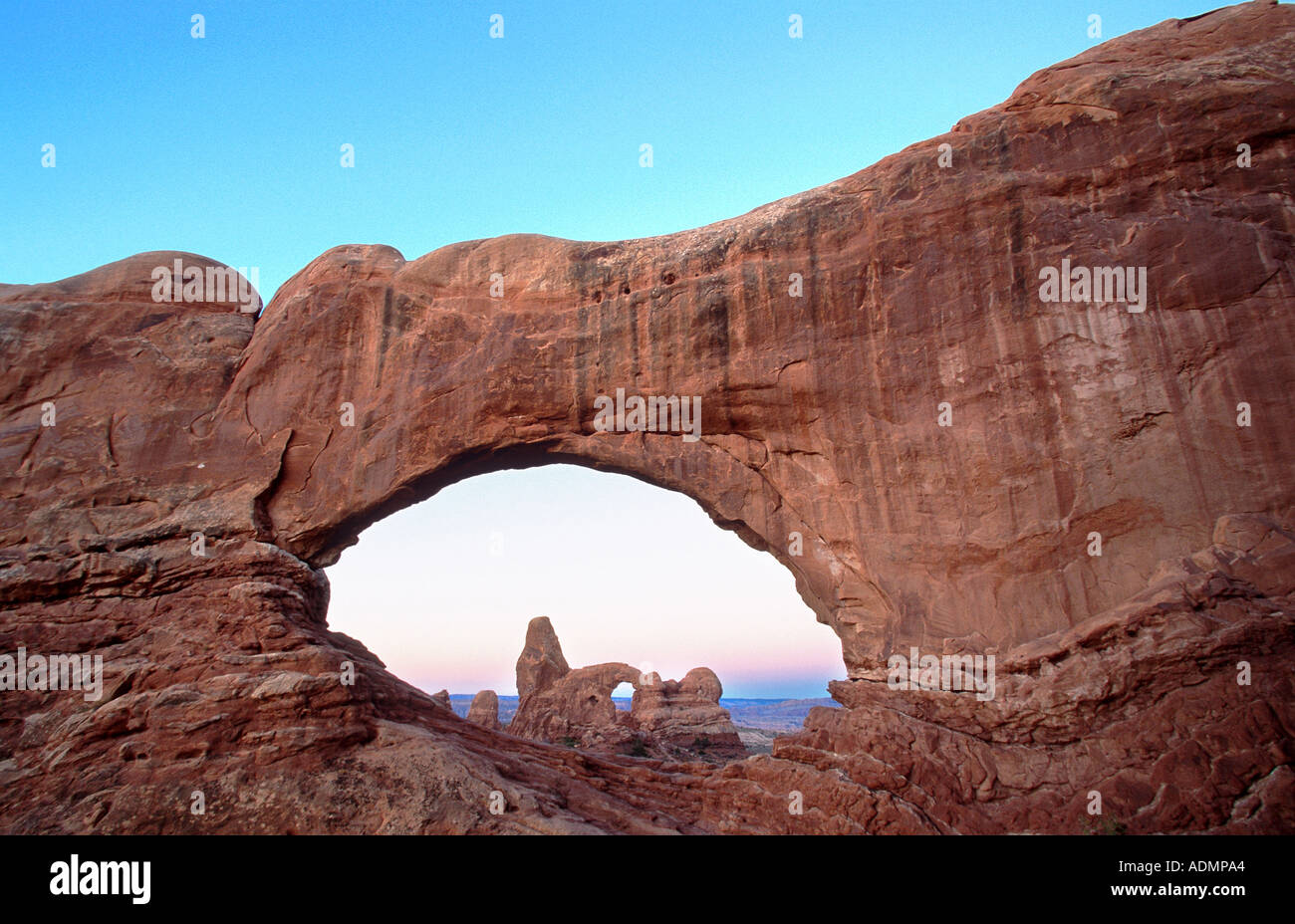 Turret Arch seen through North Window, dawn with moon, rock formation ...