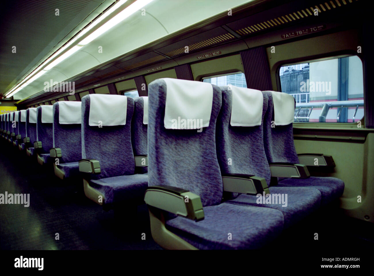 Purple seats in a commuter train Stock Photo - Alamy