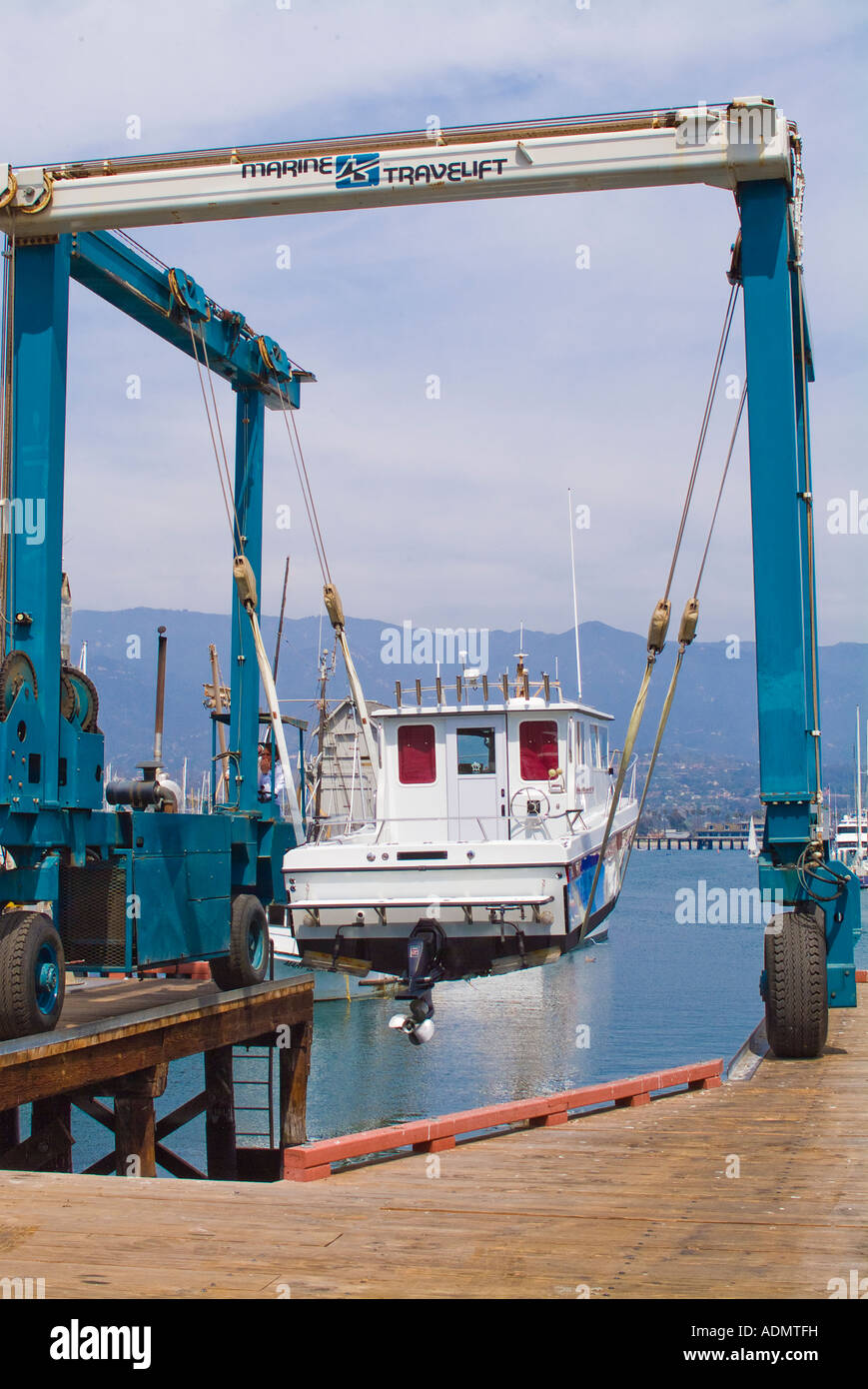 Yacht in dry dock being lifted by automated crane Stock Photo - Alamy