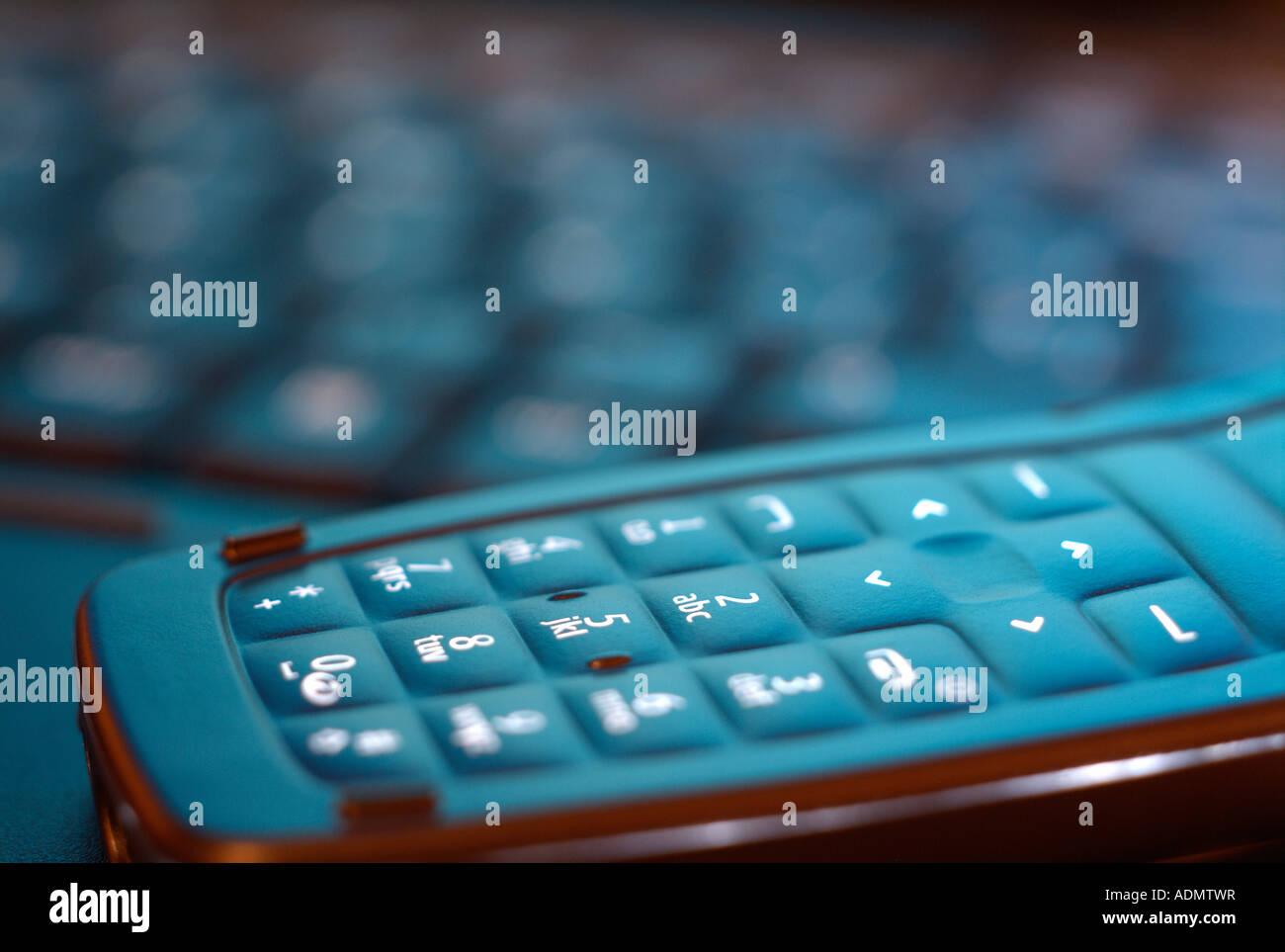 Closeup detail of a cellular phone keypad and a laptop keyboard Stock ...