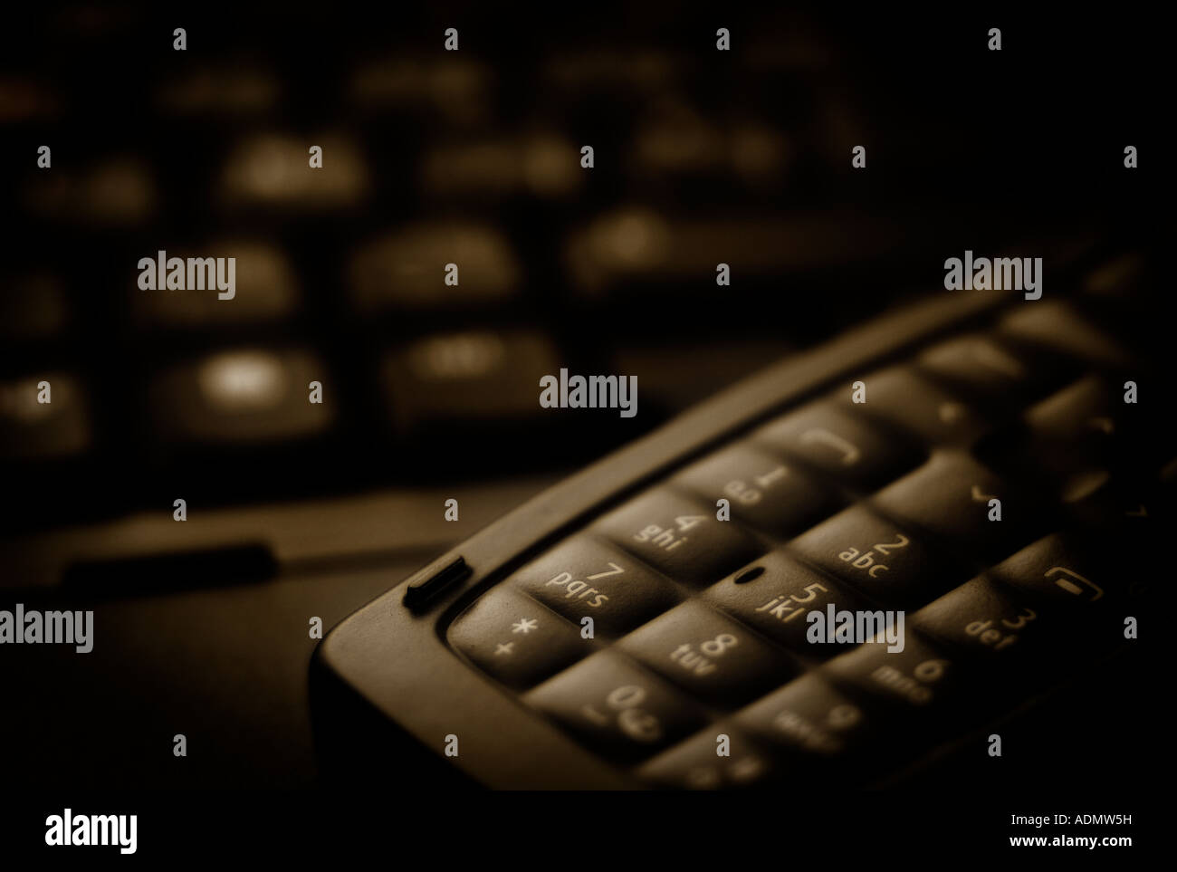 Closeup detail of a cellular phone keypad and a laptop keyboard Stock ...