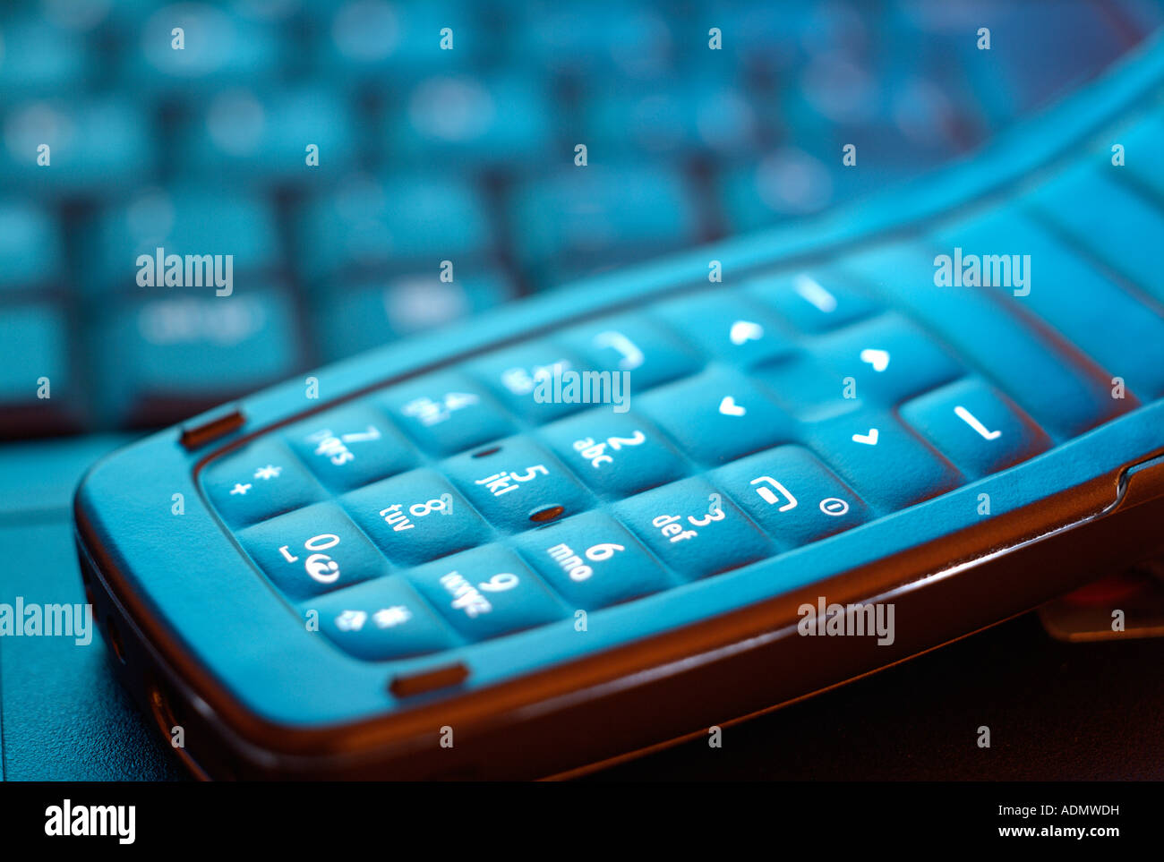 Closeup detail of a cellular phone keypad and a laptop keyboard Stock ...
