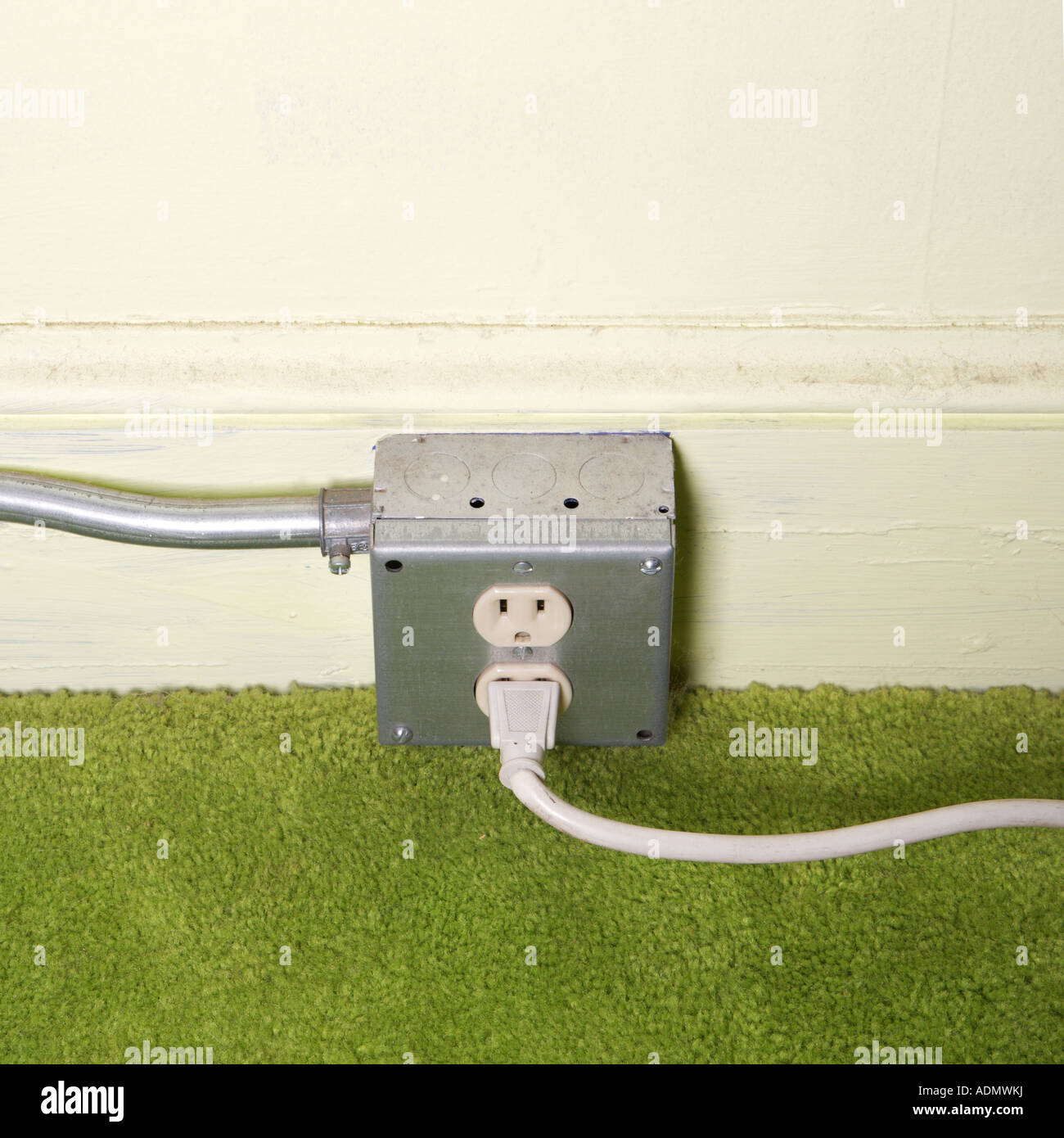 Close up of silver wall outlet with plug inserted Stock Photo - Alamy