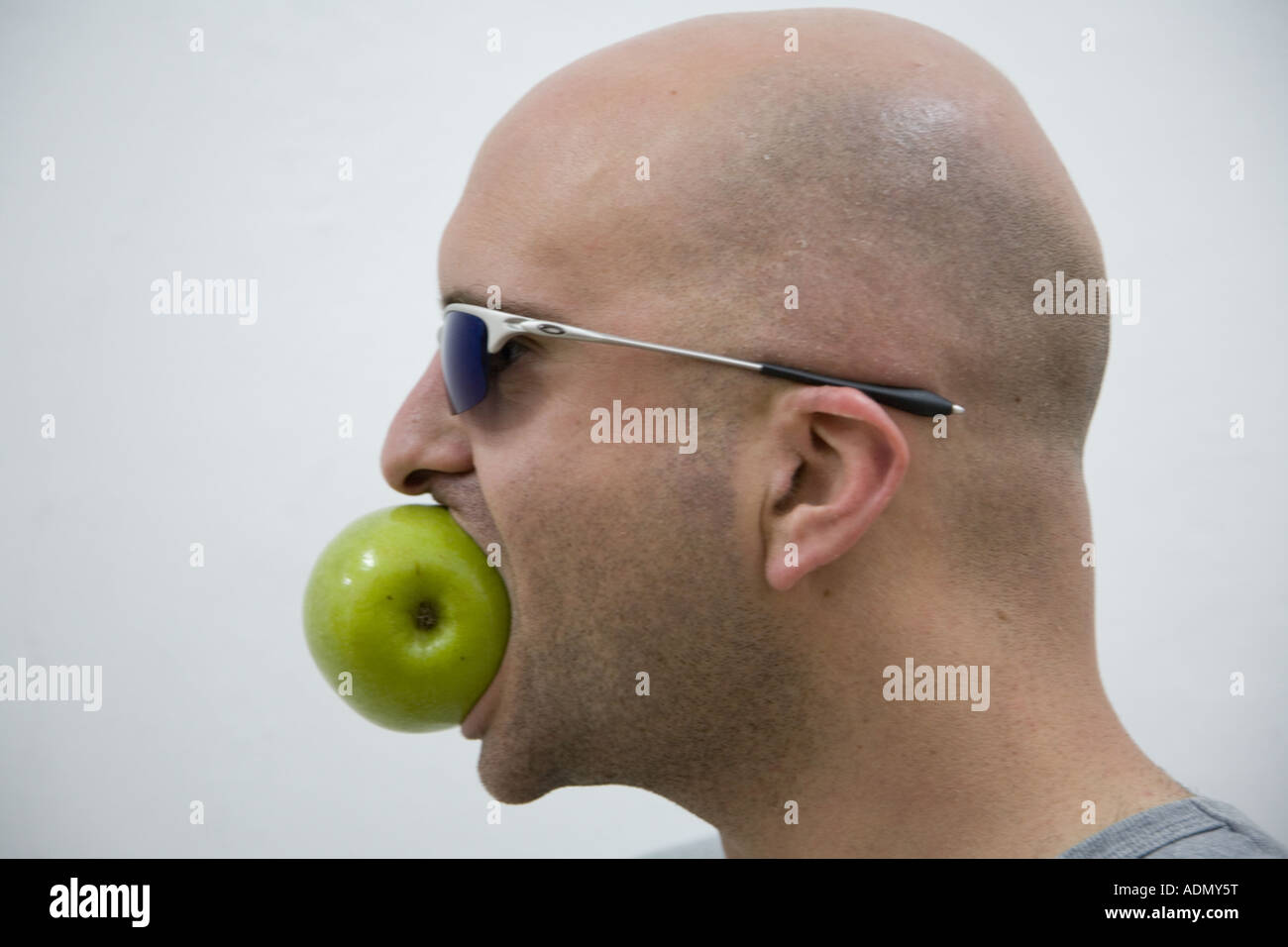 Man with apple in mouth hi-res stock photography and images - Alamy