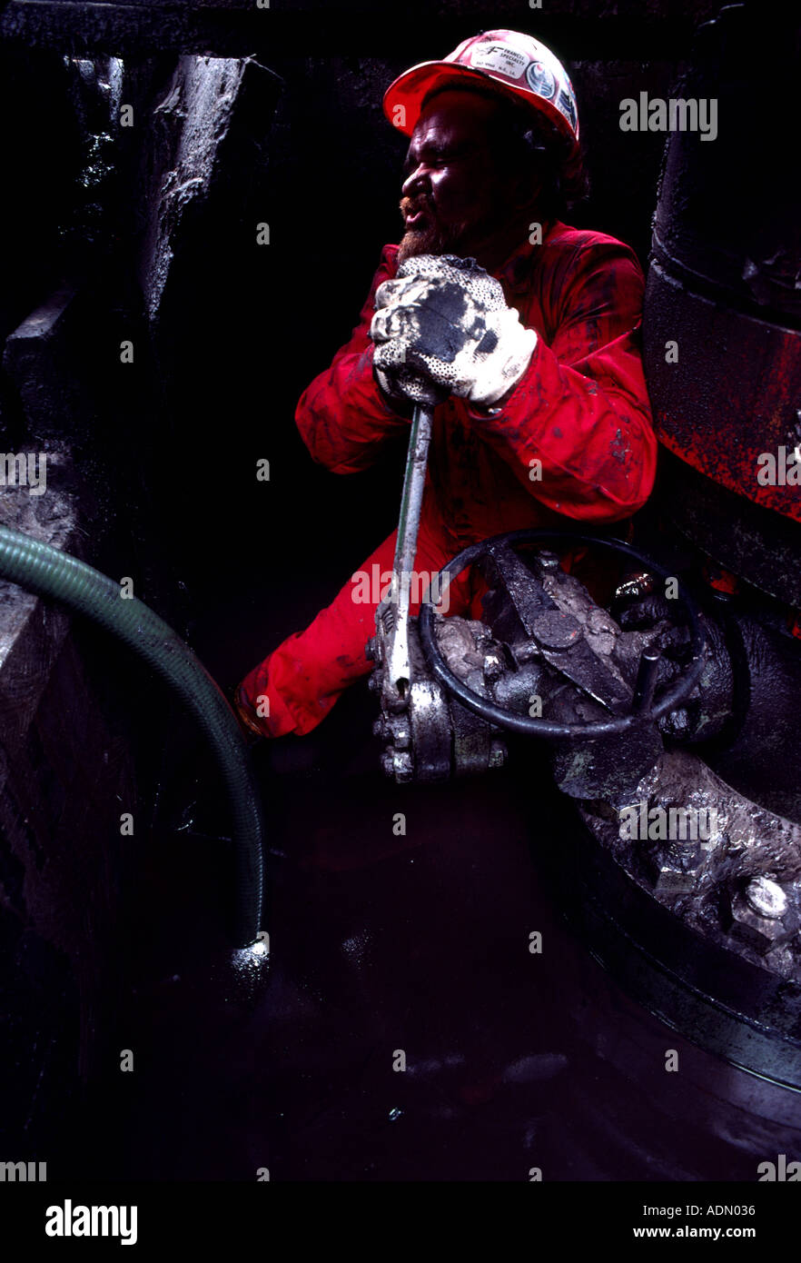 A roughneck works under the platform of an oil rig Stock Photo - Alamy