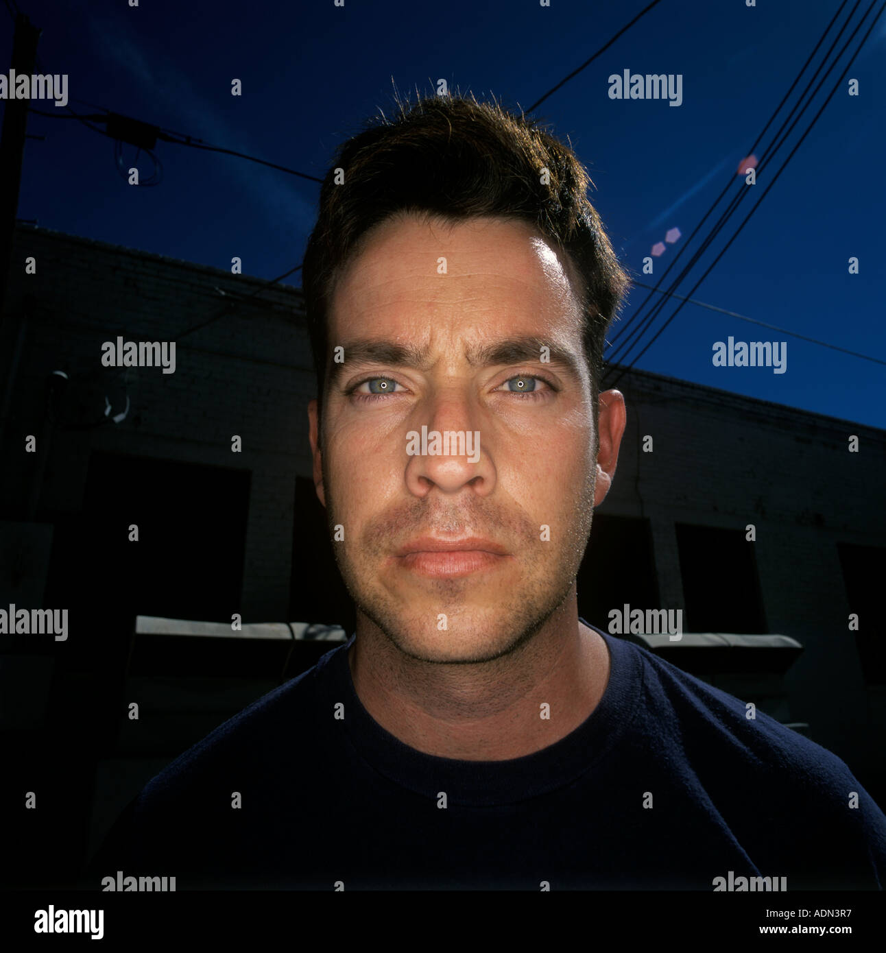 angry man stands in ally waiting Stock Photo - Alamy