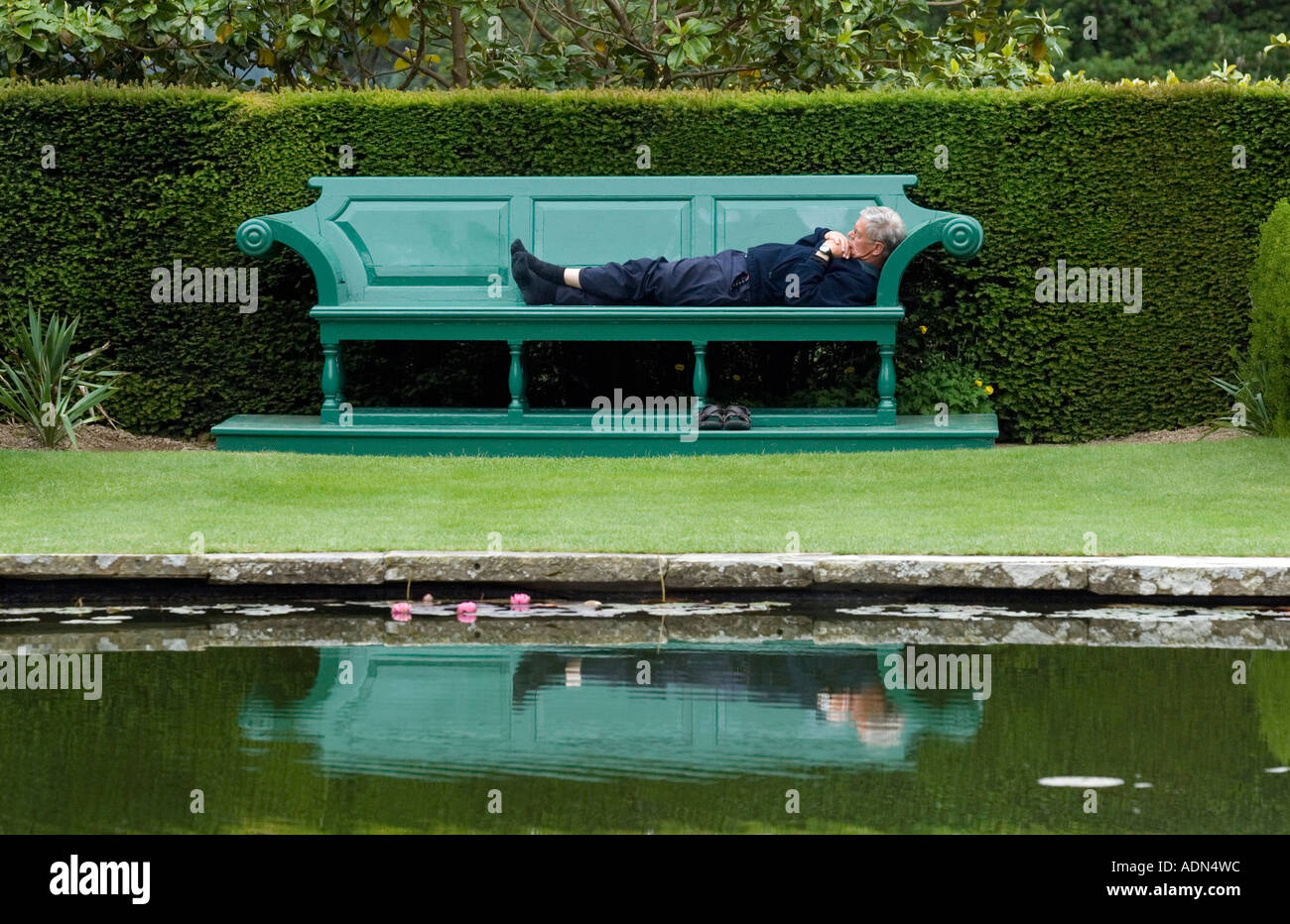 Man asleep on garden bench Stock Photo - Alamy