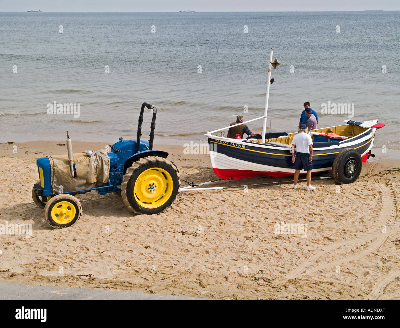 A bystander looks at the catch in a newly landed fishing boat at Redcar ...