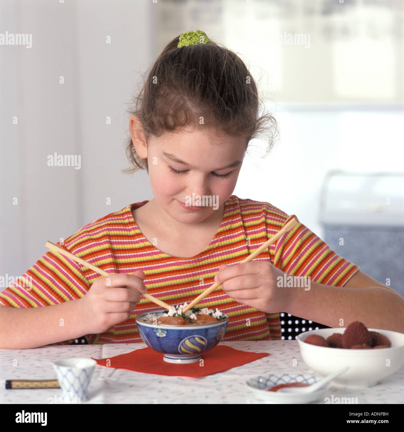 Girl eating rice with chop sticks Stock Photo - Alamy