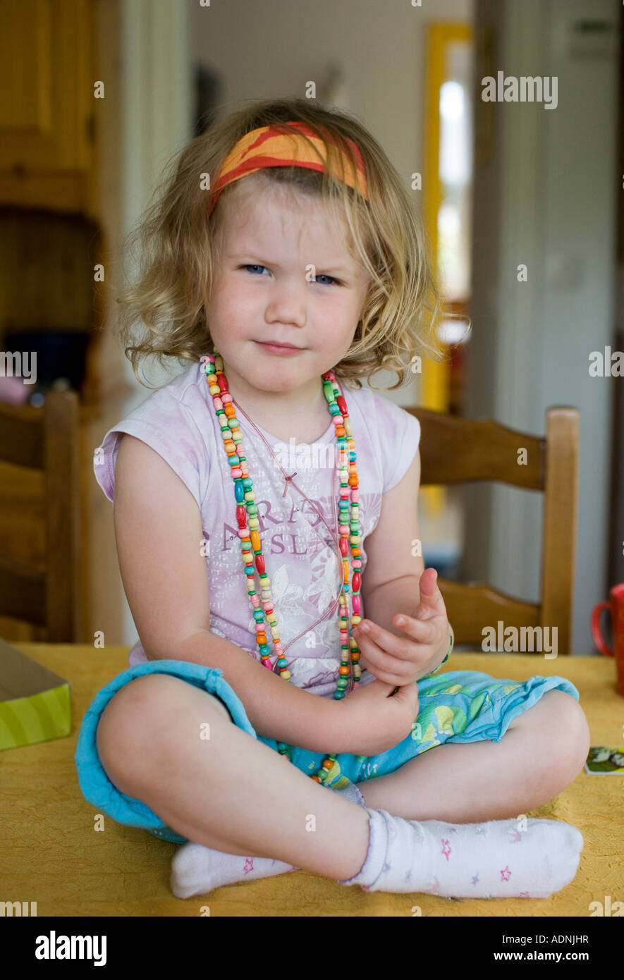 Girl Sitting on Table Stock Photo - Alamy