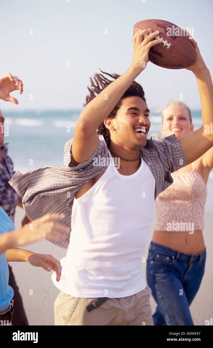 Teenagers playing football on beach hi-res stock photography and images ...