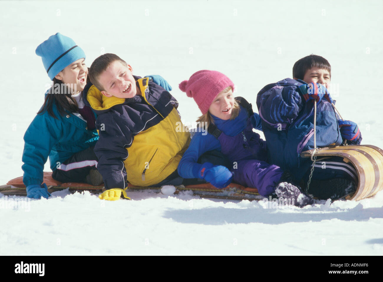 Group of children riding on a slide Stock Photo - Alamy