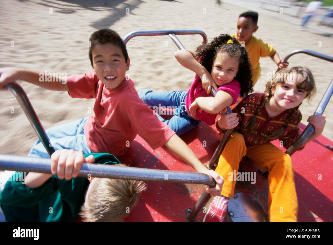 Child merry go round pushing hi-res stock photography and images - Alamy