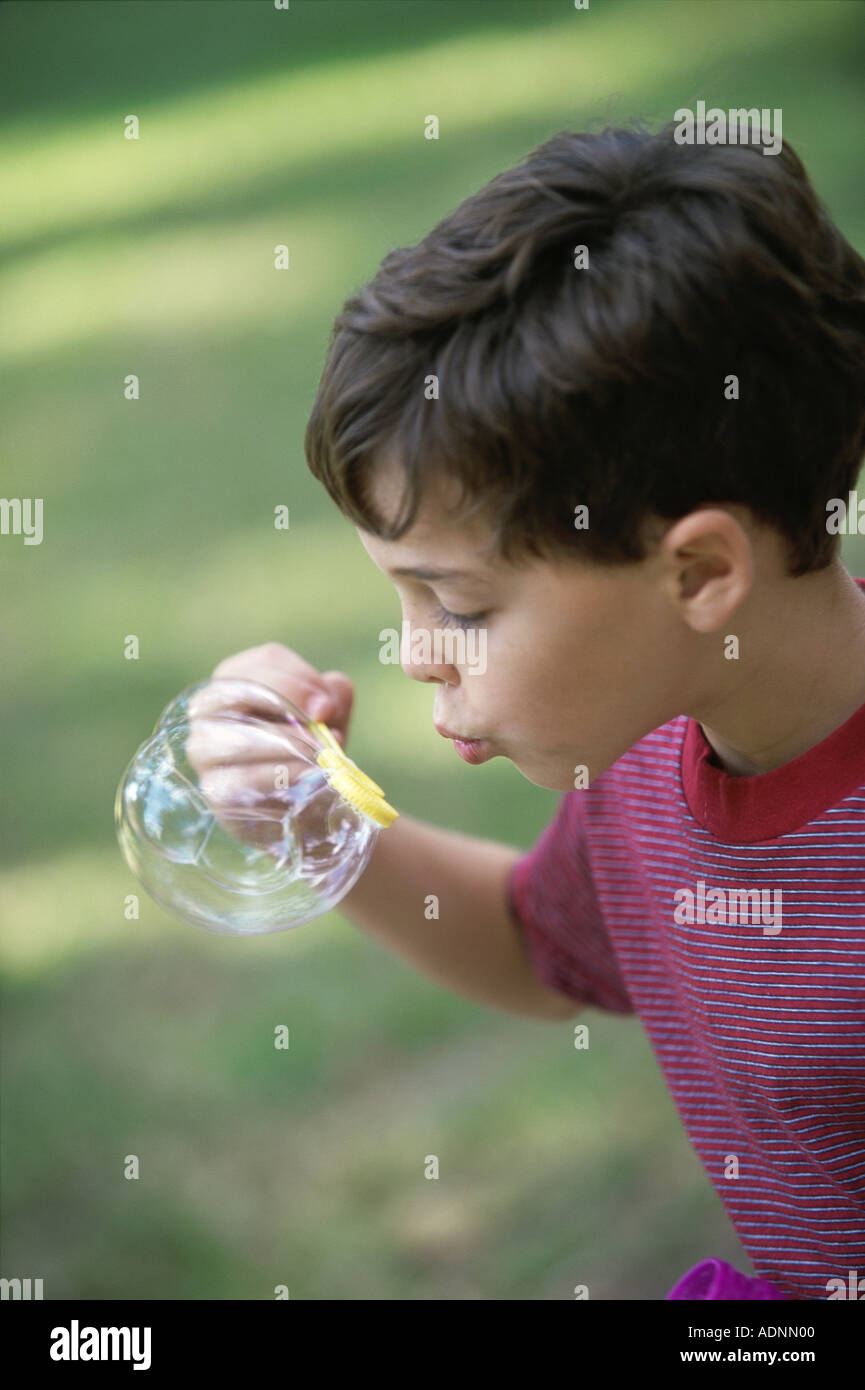 Side profile of a boy blowing bubbles Stock Photo - Alamy