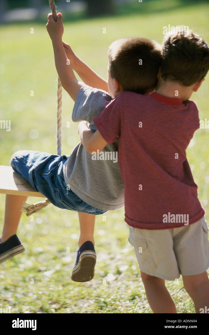 Two boys playing on swing hi-res stock photography and images - Alamy