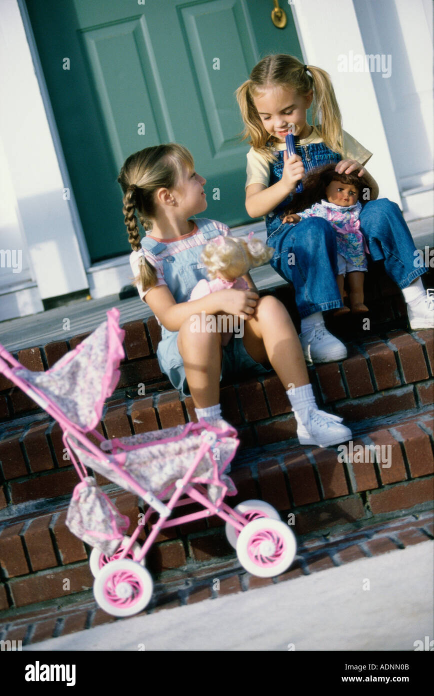 Two girls playing with dolls hi-res stock photography and images - Alamy