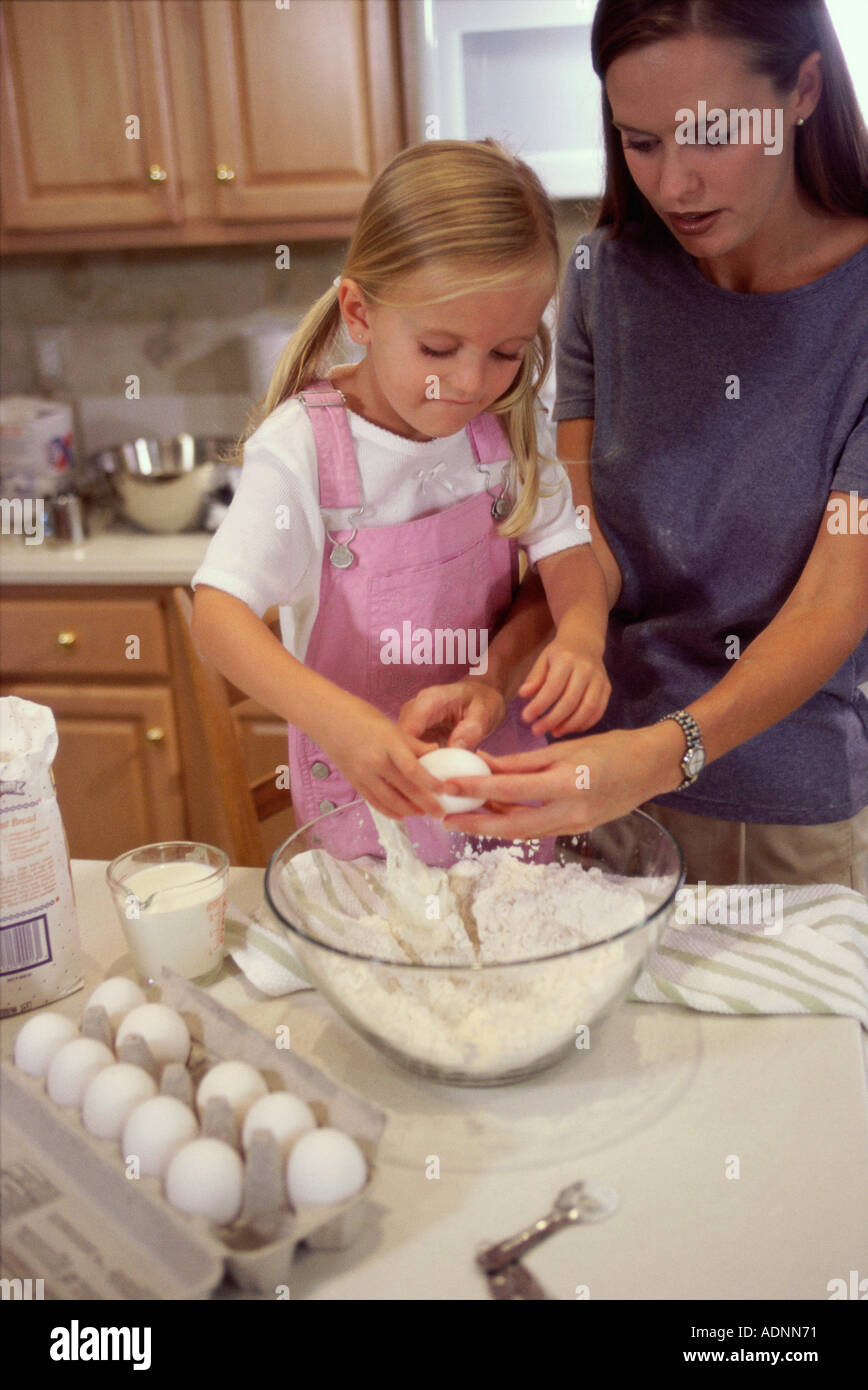 Black woman breaking egg in kitchen hi-res stock photography and images - Alamy