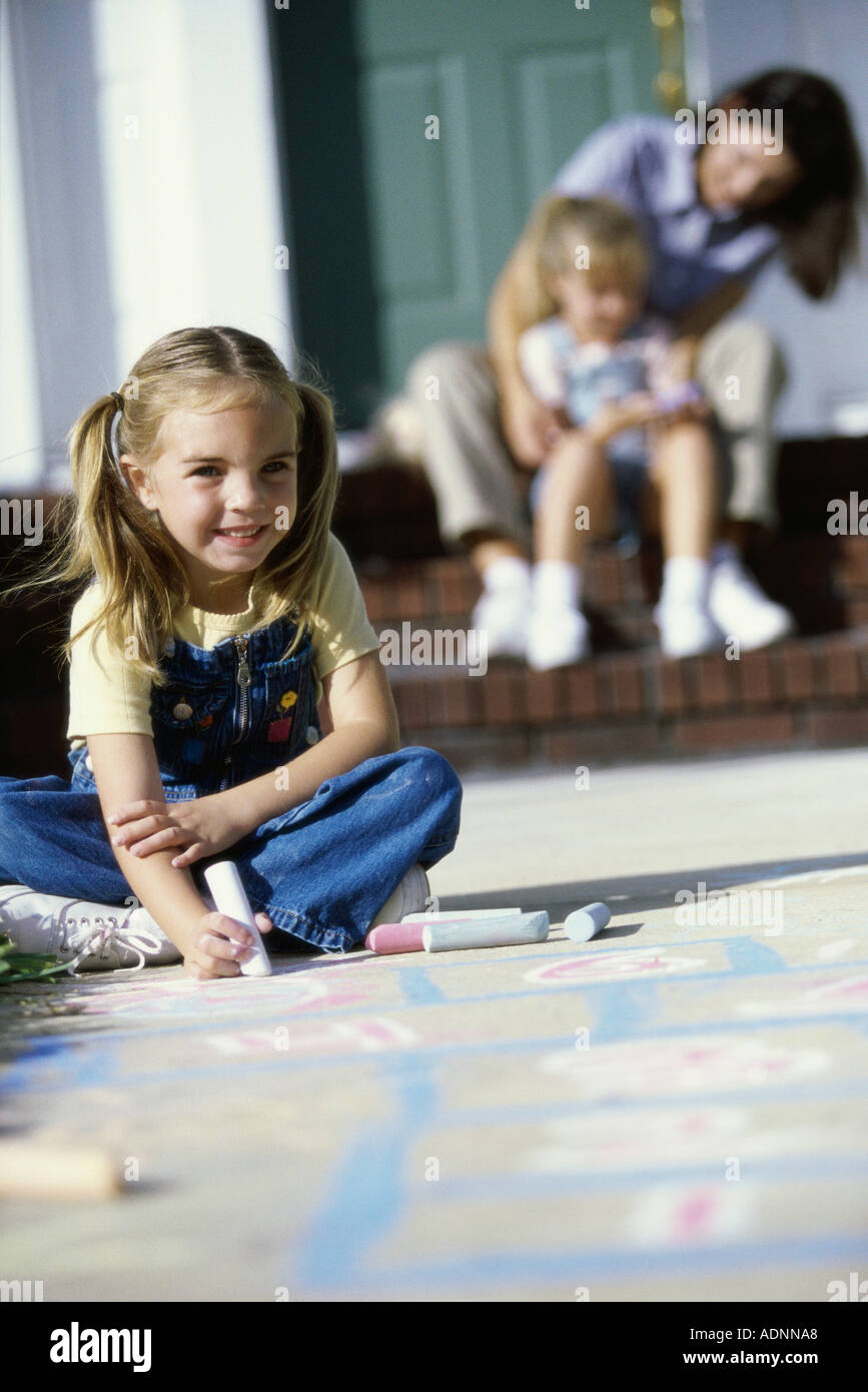 Portrait of a girl drawing on the floor with chalk Stock Photo - Alamy