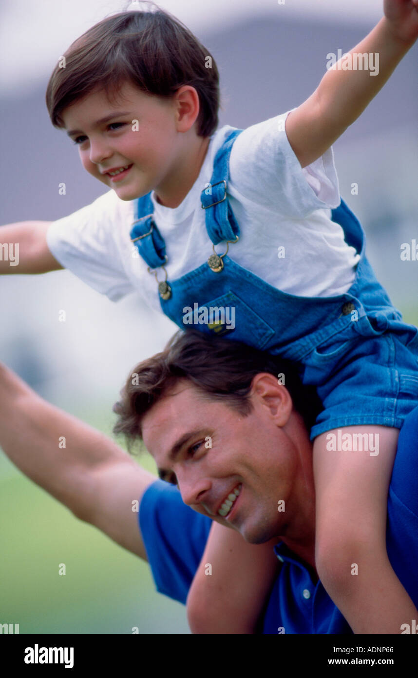 Father carrying his son on his shoulders Stock Photo - Alamy