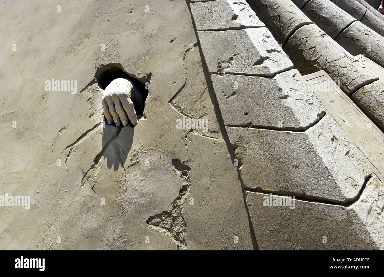A spooky sand hand coming out of a tomb sculpted in sand at Black Rock ...