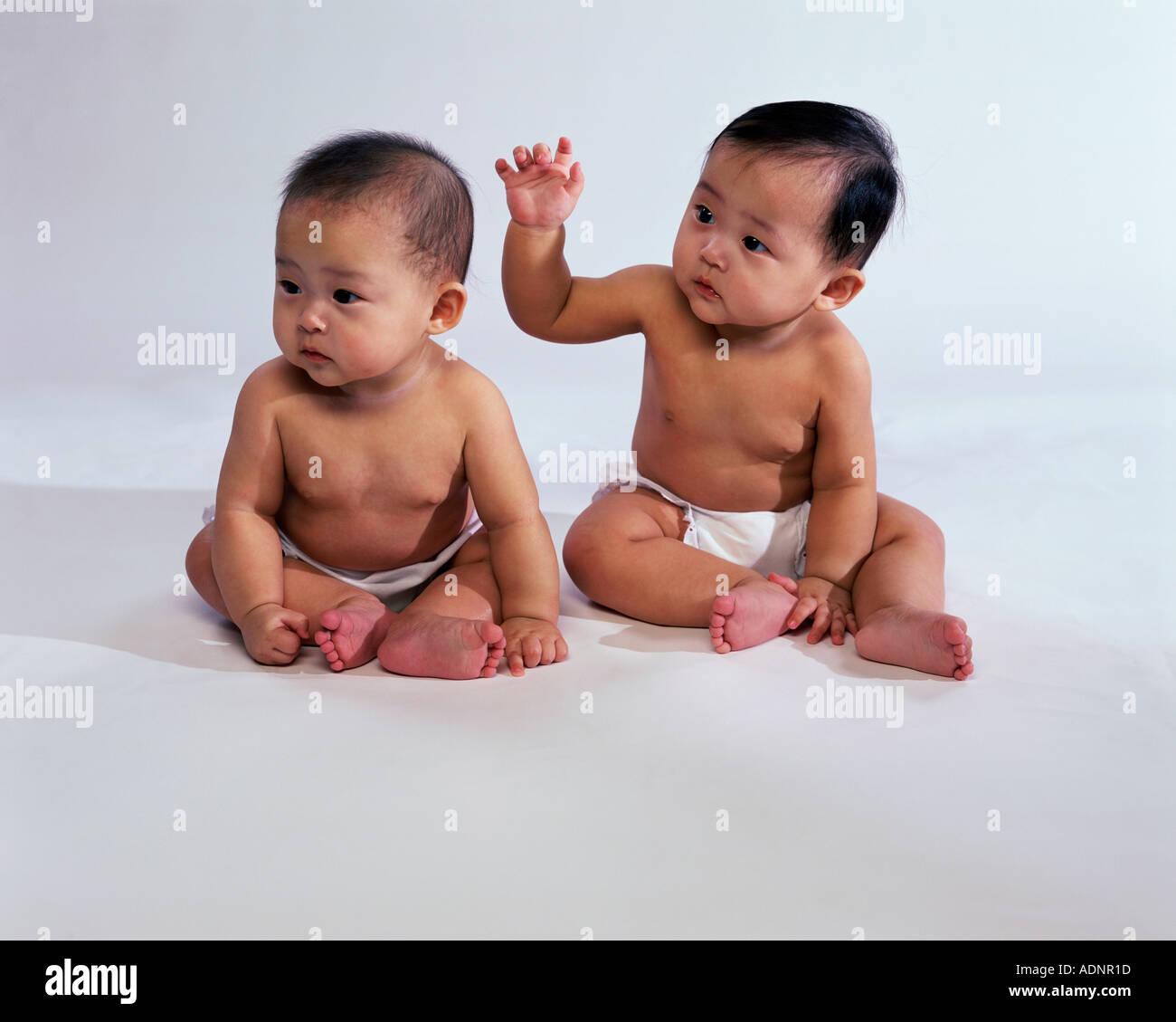 Two baby boys wearing diapers Stock Photo - Alamy