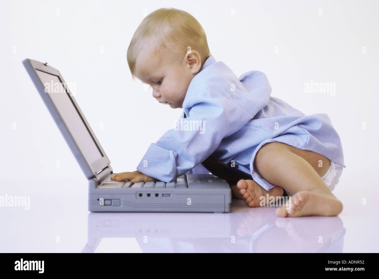 Side profile of a baby boy touching a laptop Stock Photo - Alamy