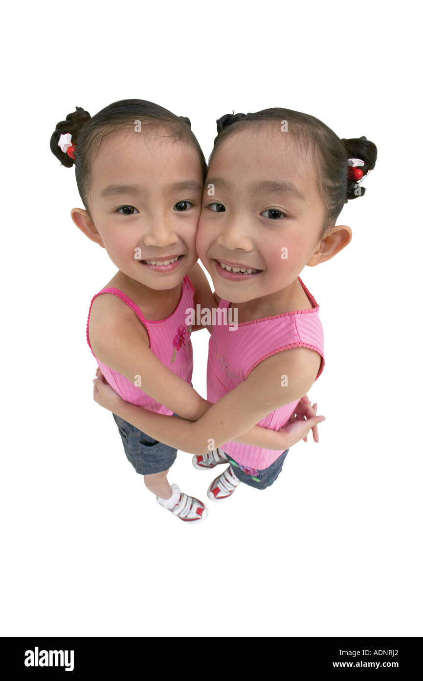 Two girls children hugging Cut Out Stock Images & Pictures - Alamy
