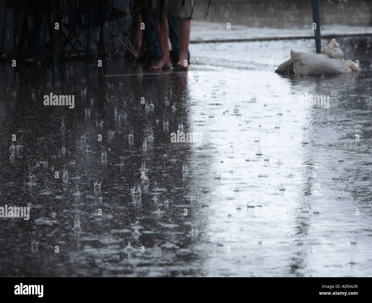 Torrential rain falling onto a pavement in Hunstanton with bare feet ...