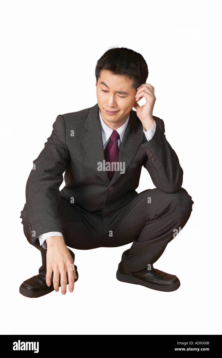 Man black suit crouching hi-res stock photography and images - Alamy