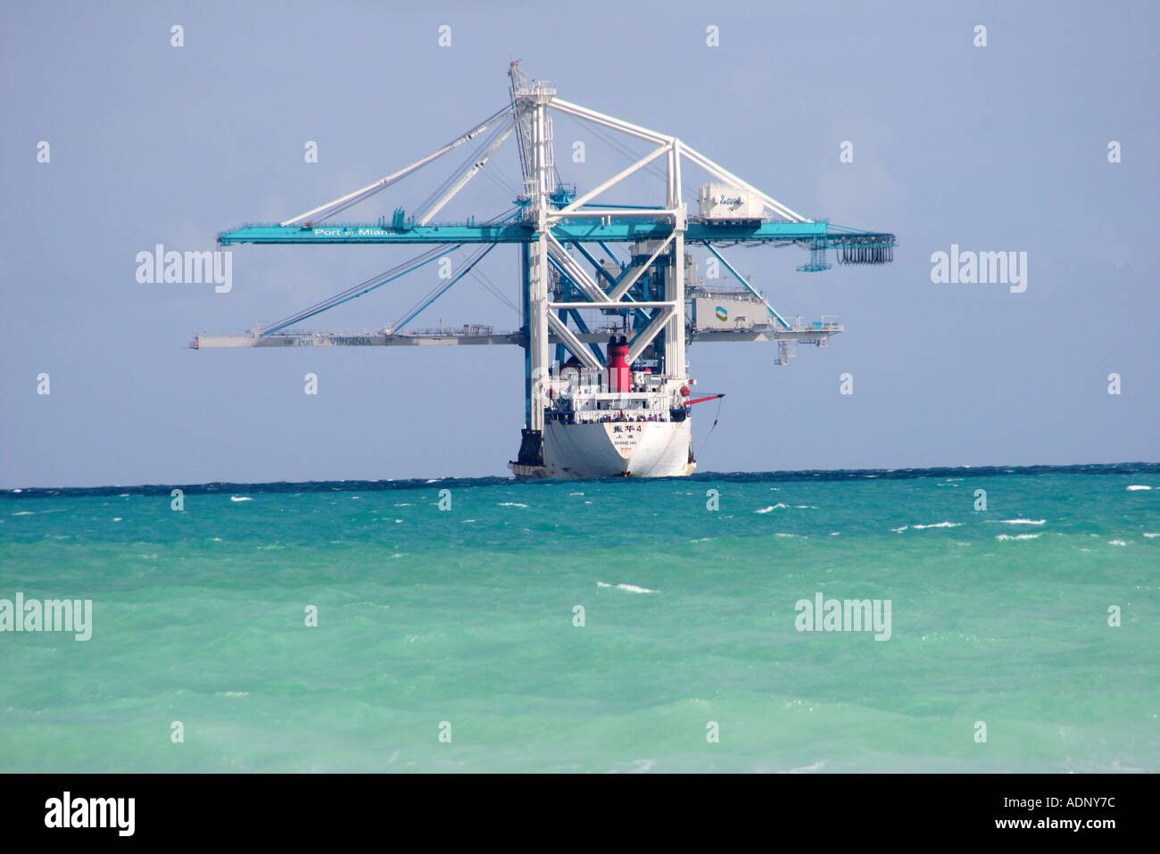 Atlantic ocean water cargo ship delivering new port lifting cranes hi ...
