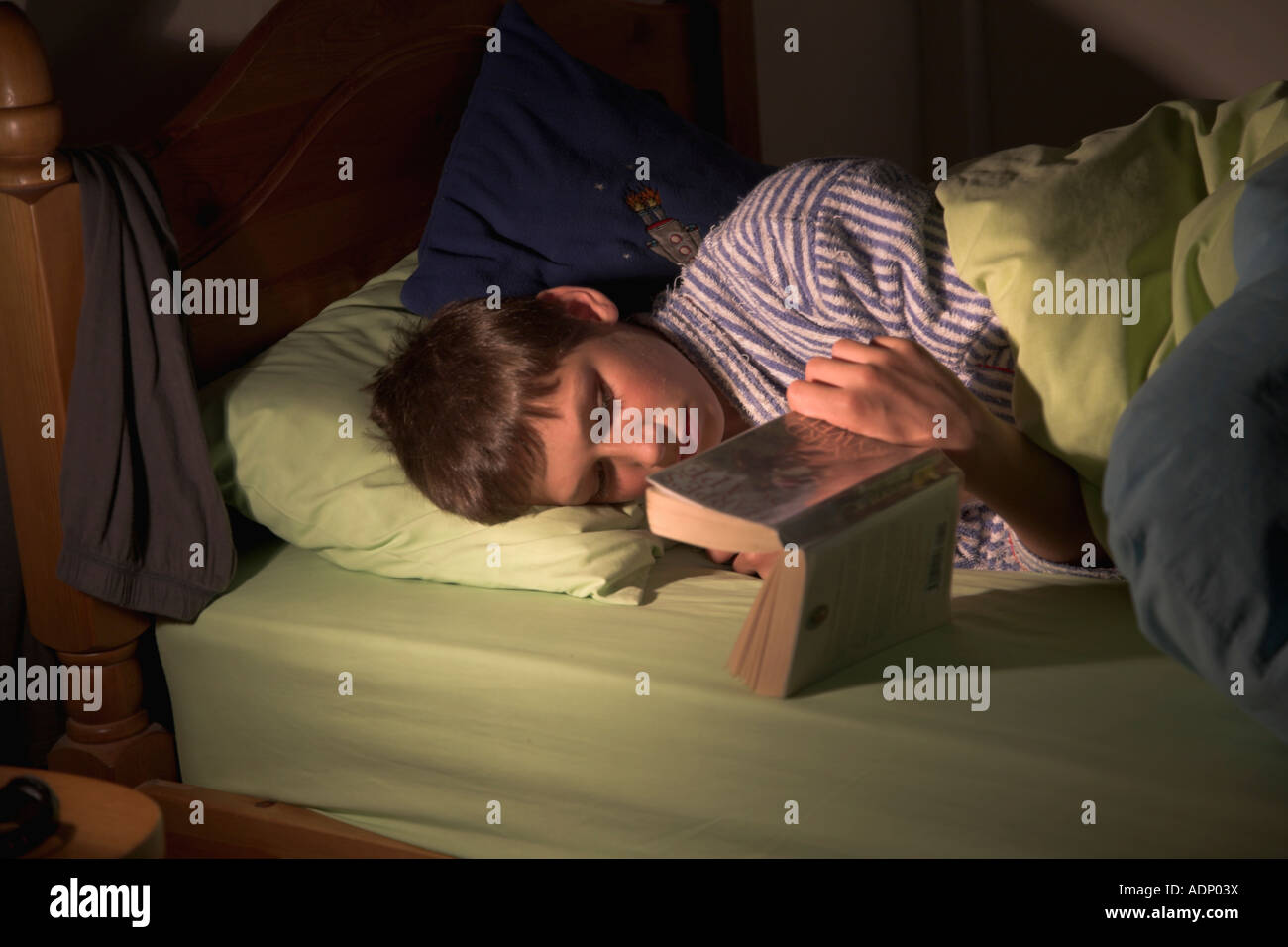 Teen boy reading in bed hi-res stock photography and images - Alamy