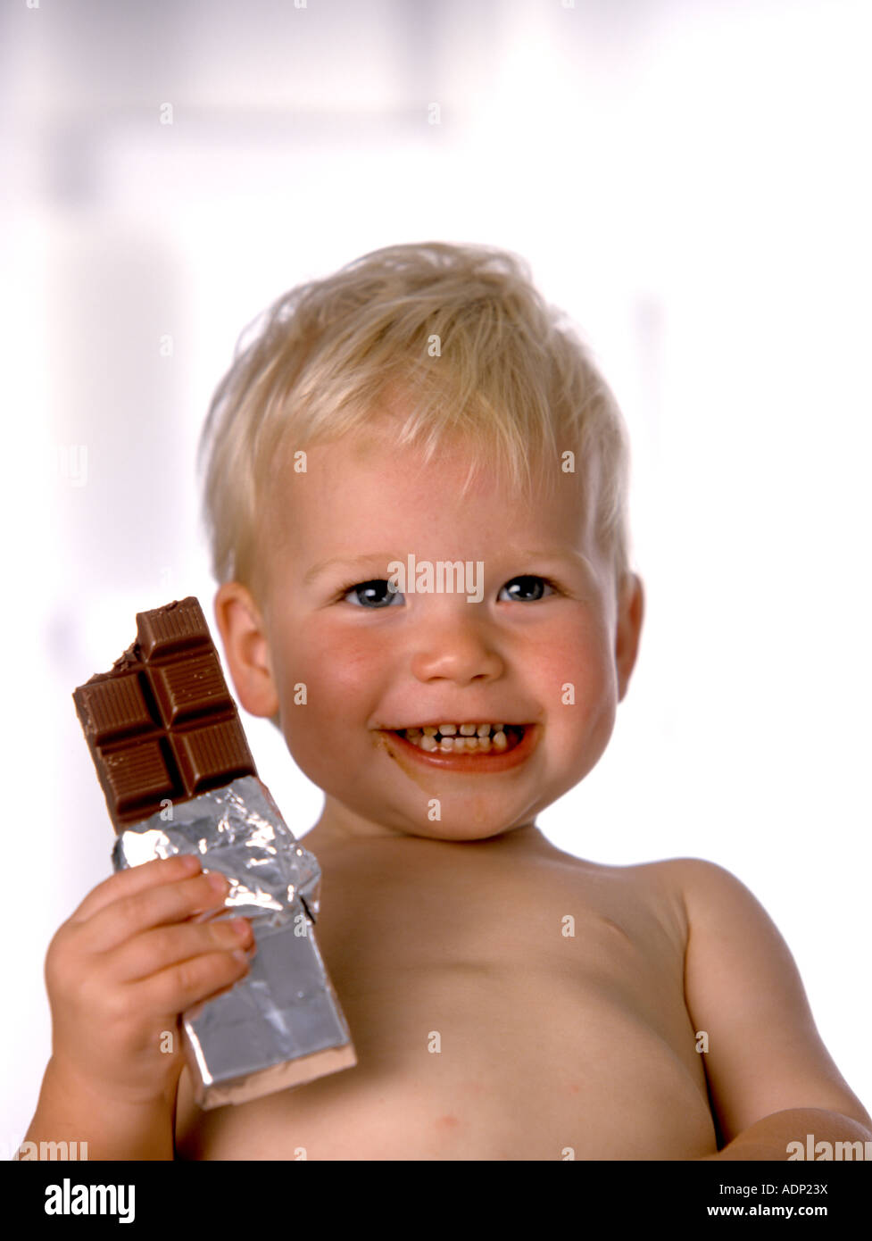 Little girl is eating a bar of chocolate Stock Photo - Alamy