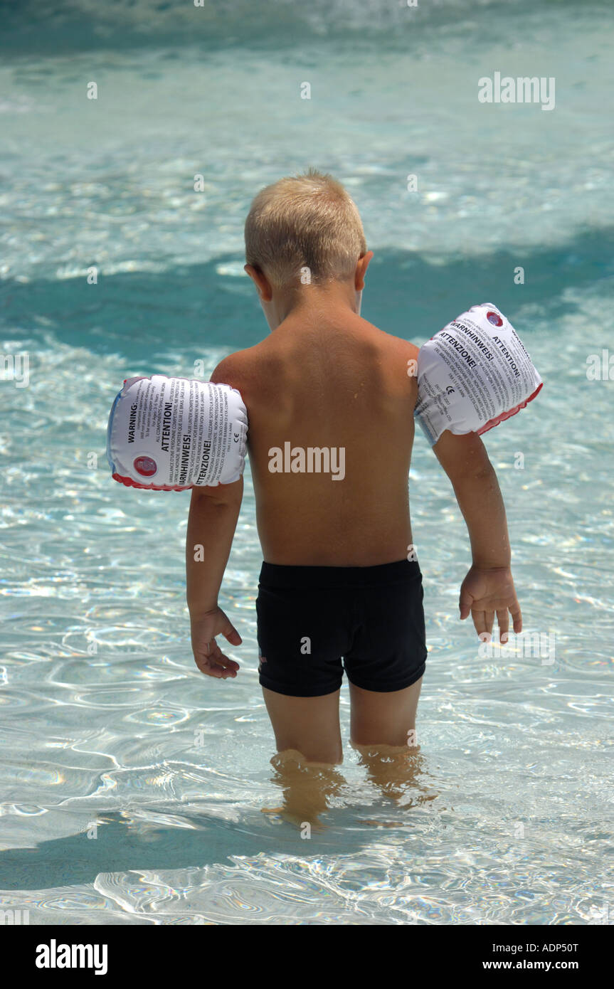 Child wearing inflatable swimming arm bands in a pool Stock Photo - Alamy
