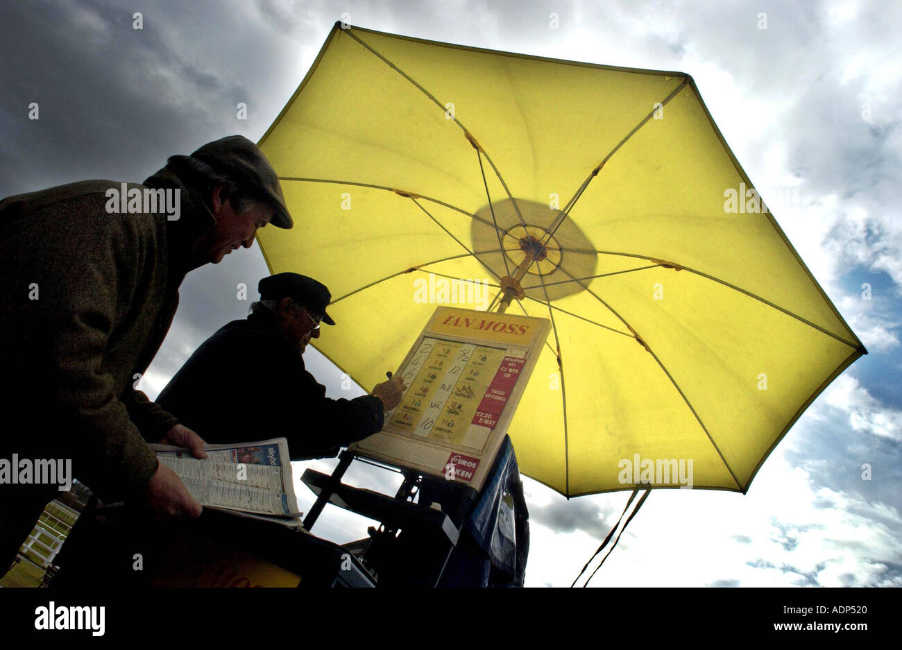 Heavy going for two damp bookmakers on a wet day at the races Stock ...