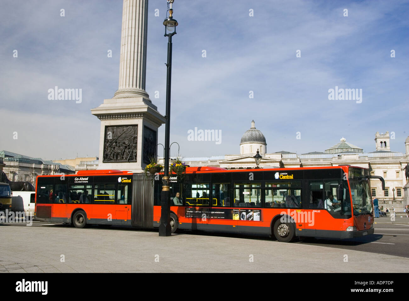 Public transport single decker bendy bus travelling in Trafalgar Square ...