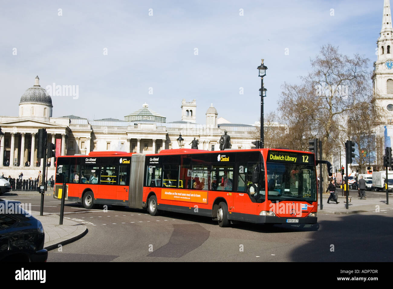 Public transport single decker bendy bus travelling in Trafalgar Square ...