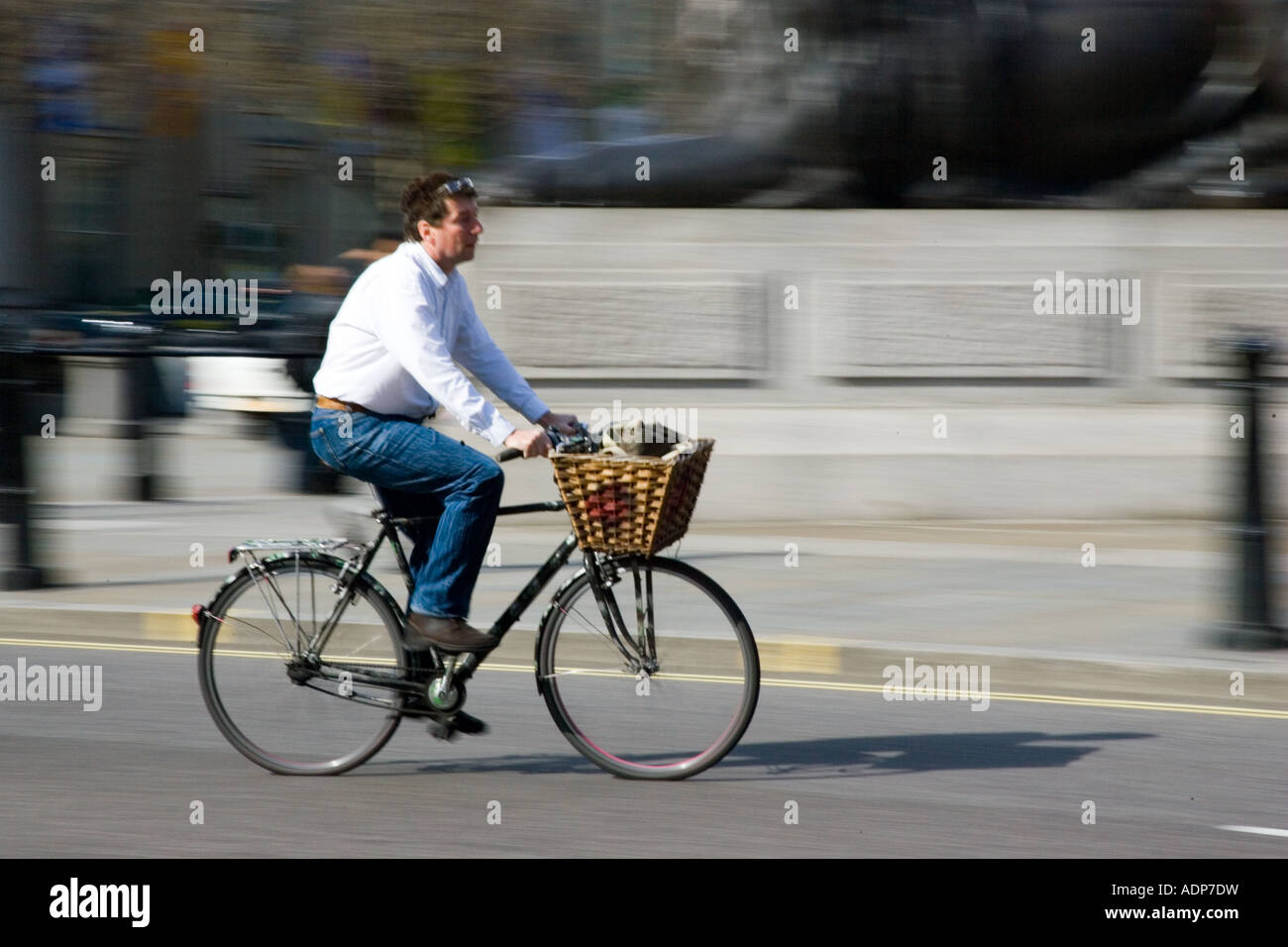 Cyclist riding a bicycle in Trafalgar Square London England United ...