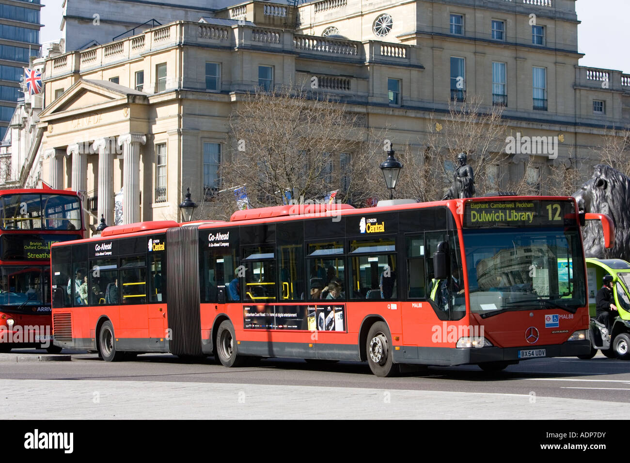 Public transport single decker bendy bus travelling in Trafalgar Square ...