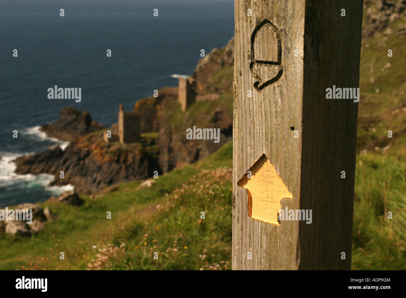 Footpath direction sign with Crown engine houses at Botallack Cornwall ...