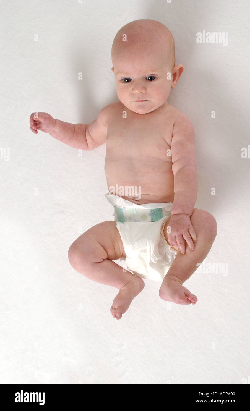 Baby lies full lenght on the floor Stock Photo - Alamy