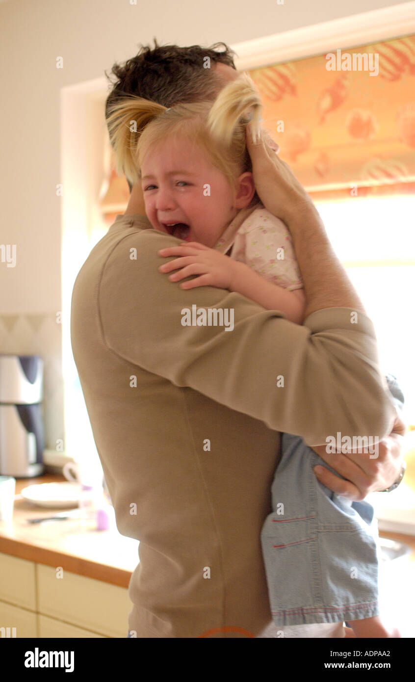 Father carrying a crying child Stock Photo - Alamy
