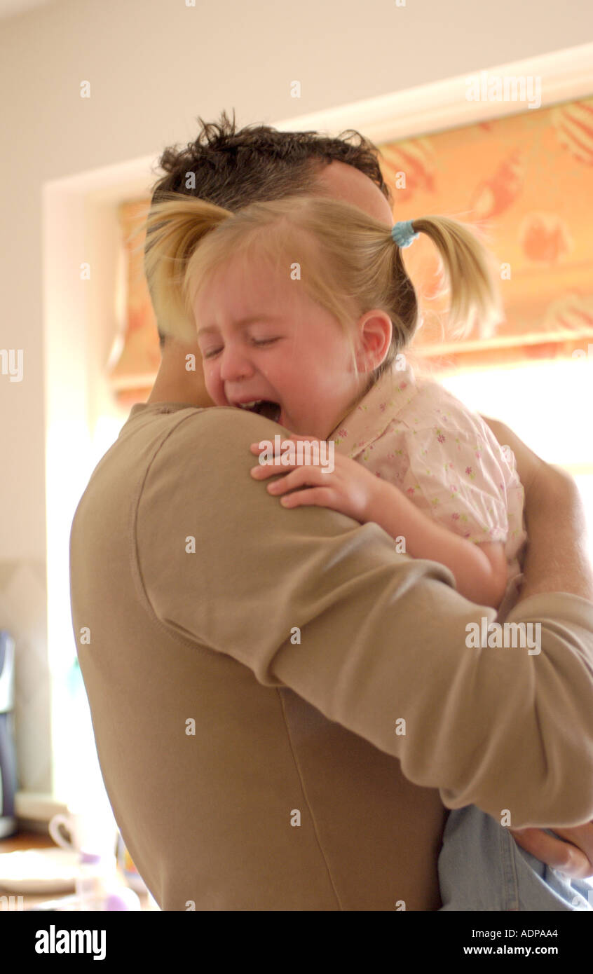 Father carrying a crying child Stock Photo - Alamy