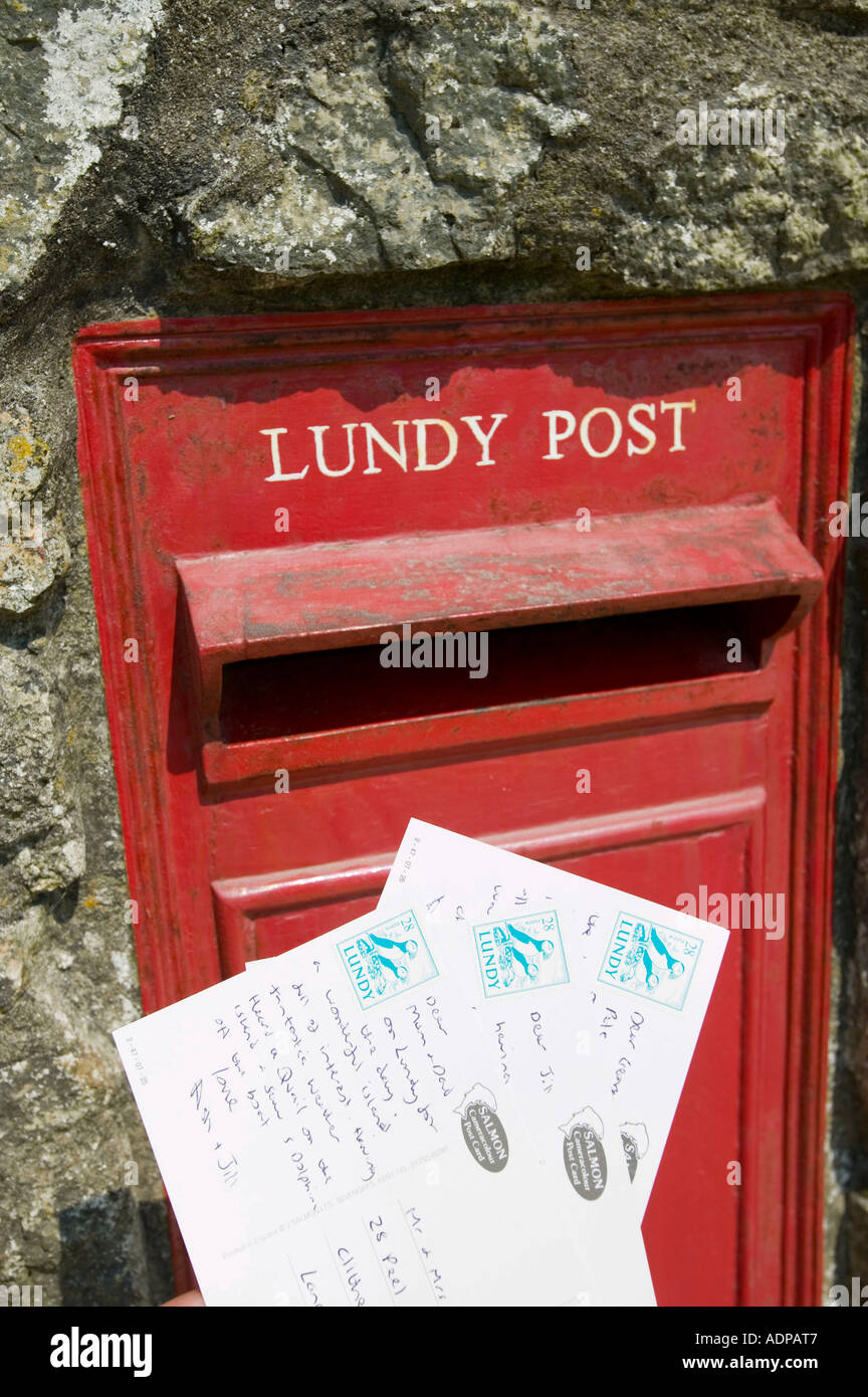 posting postcards from lundy island in a Lundy postbox, North Devon, UK ...