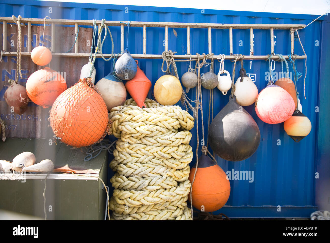 Colourful buoys and rope at harbour's edge Stock Photo - Alamy
