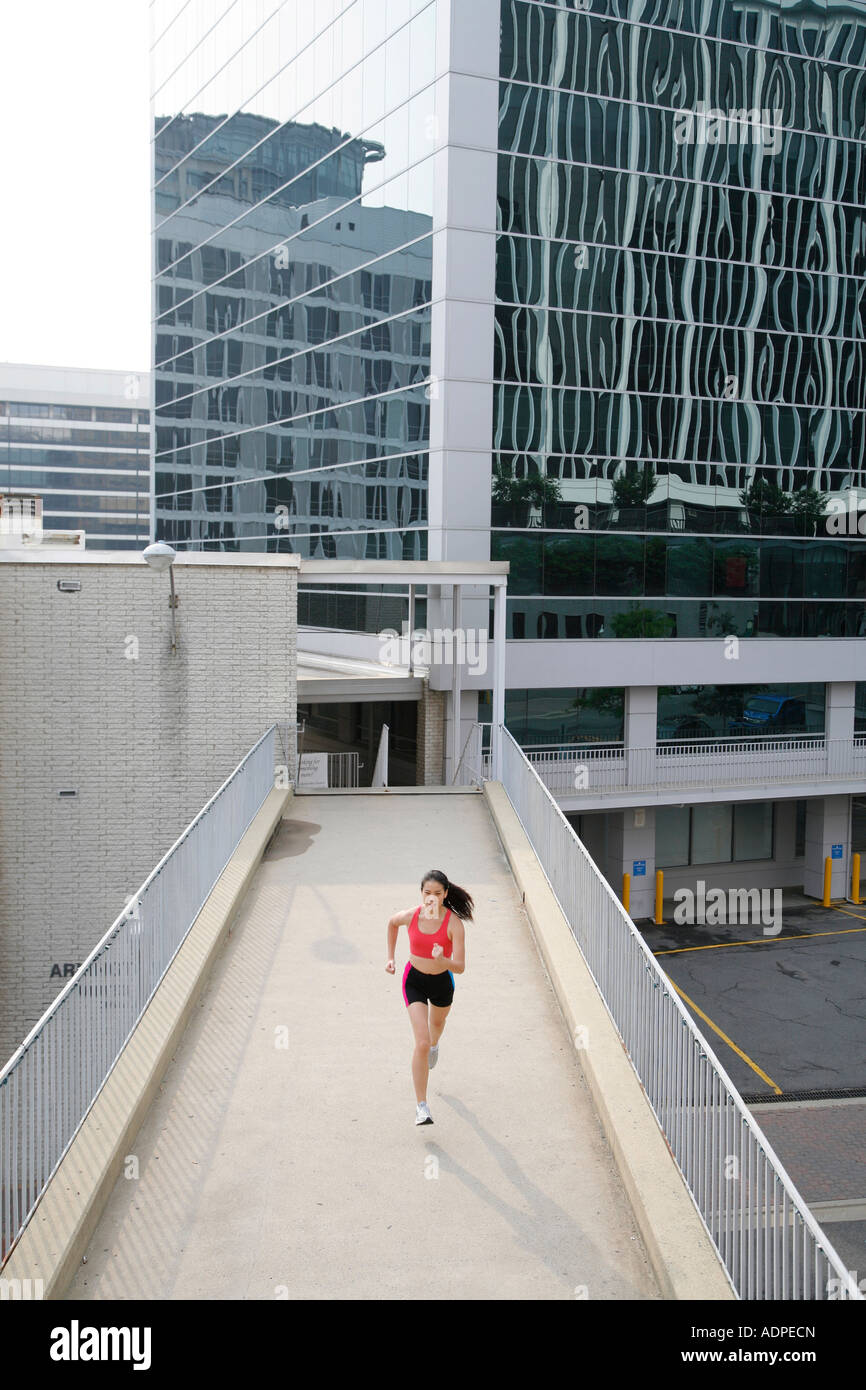 Young woman, 23, Asian American, Chinese, running, urban scene ...